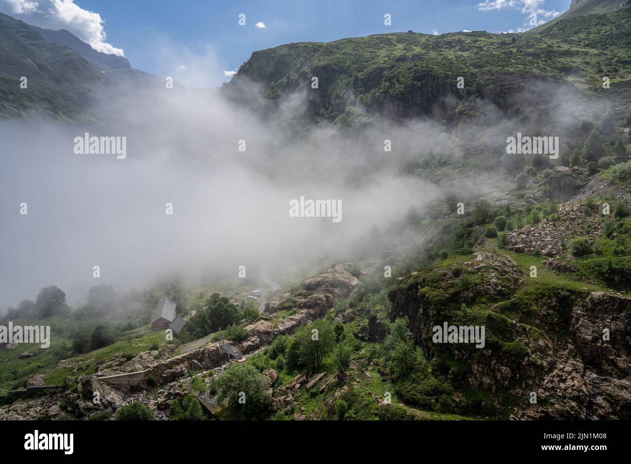 cloud rising up the valley below the barrage des gloriettes, a large ...