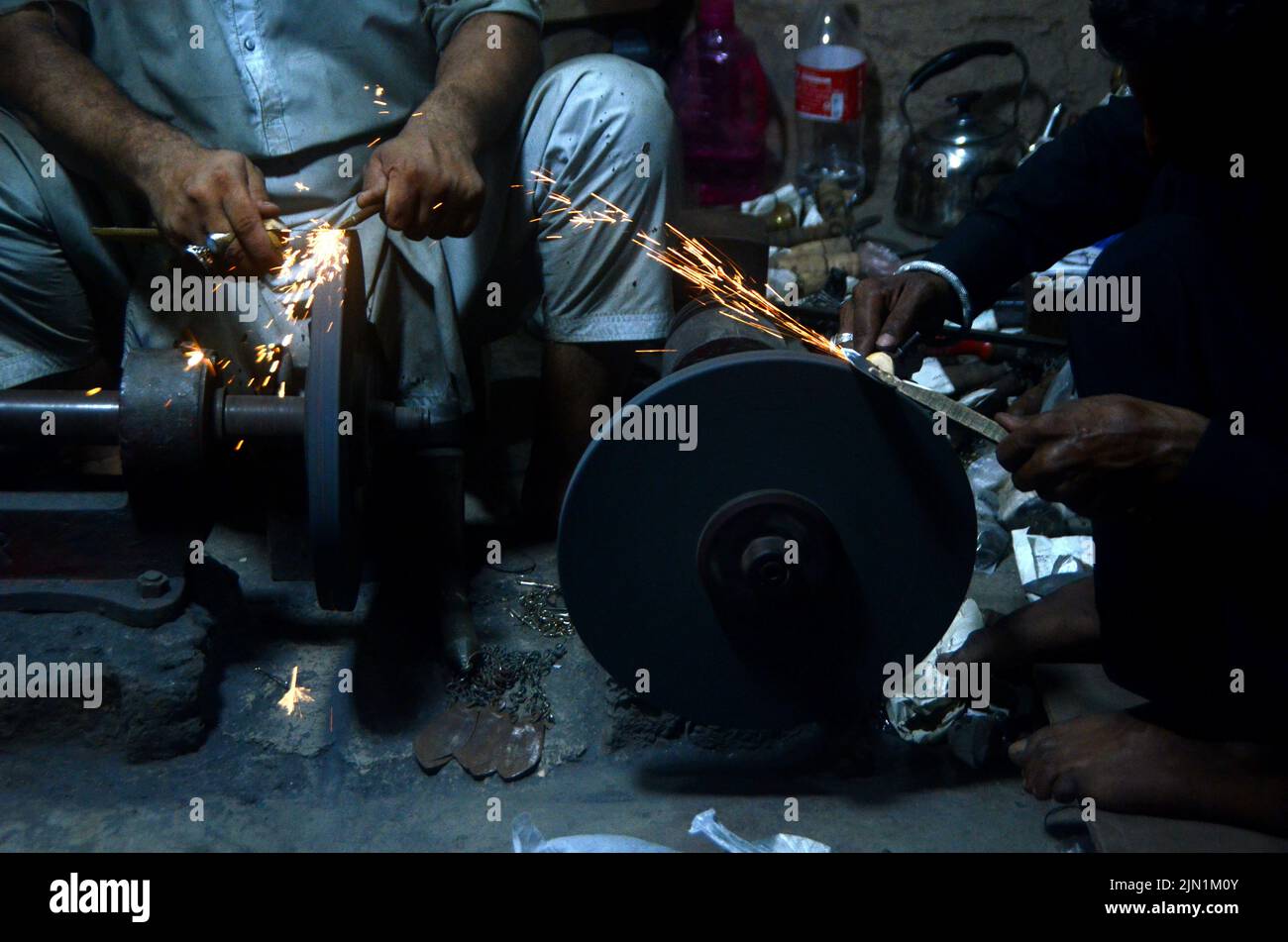 Peshawar, Pakistan. 07th Aug, 2022. An ironsmith sharpens knives to be ...