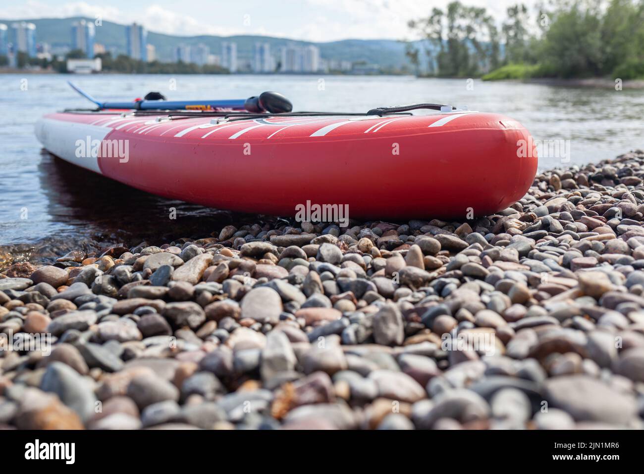 SUP board on the river bank. Paddle board on the lake shore. Supboard ...