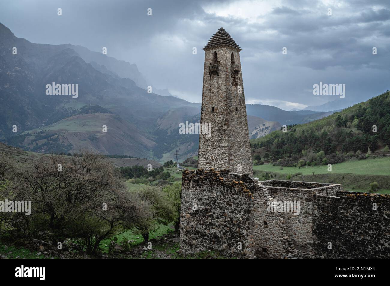 Ancient tower of the Medieval Complex Egikal against mountains and ...