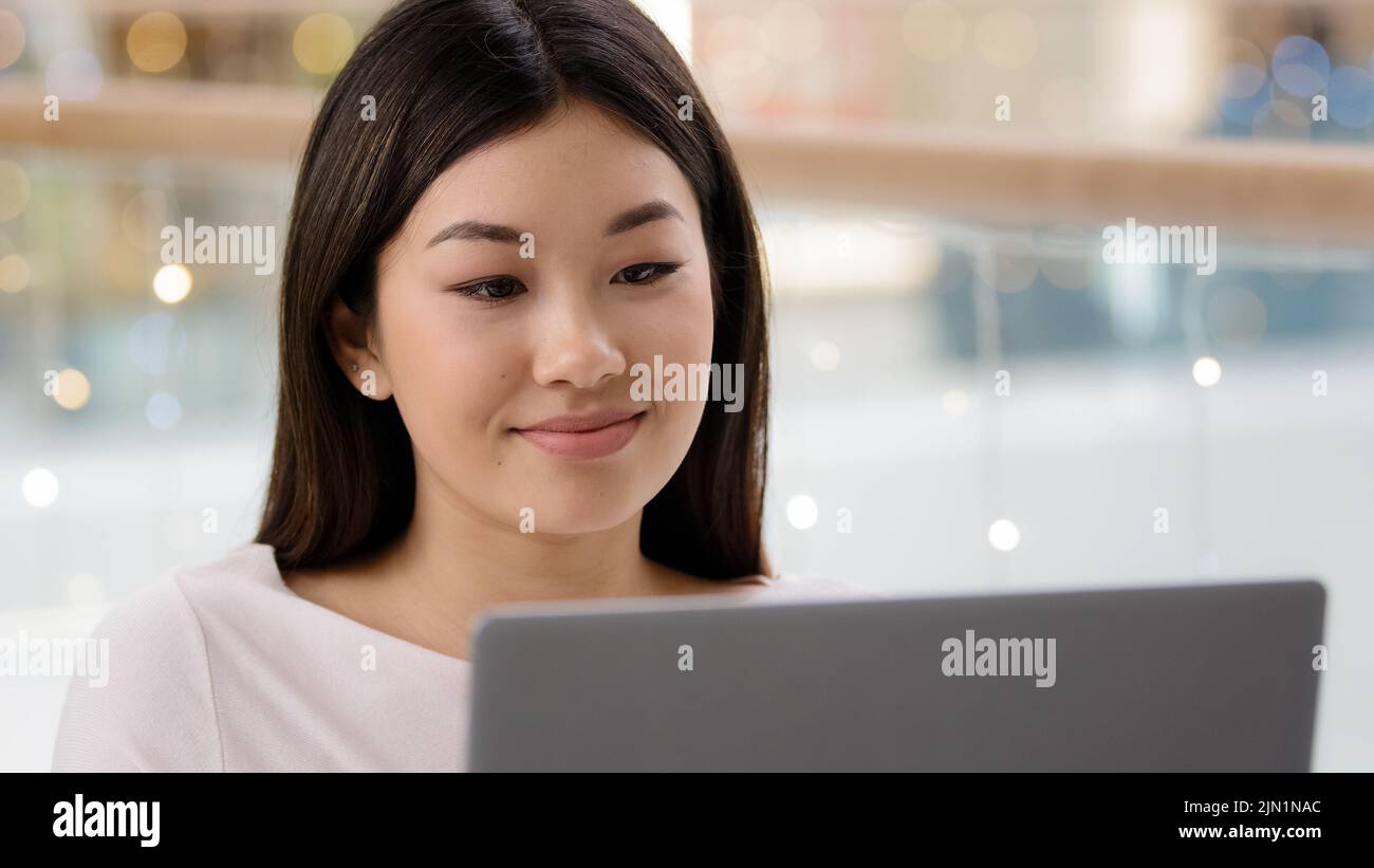 Portrait asian female face looking at laptop satisfied girl woman ...