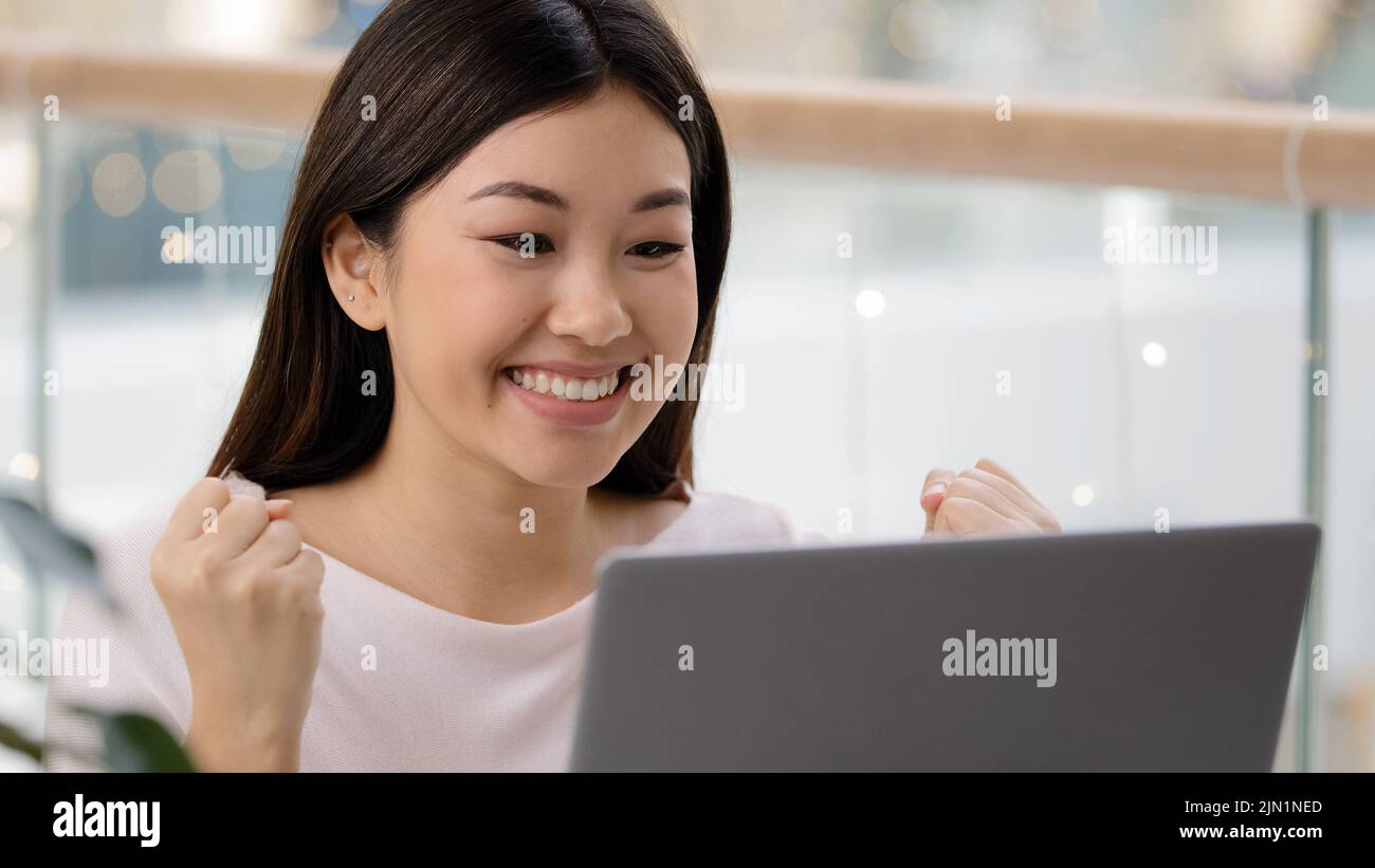 Korean Asian happy woman with laptop excited surprised smile got ...