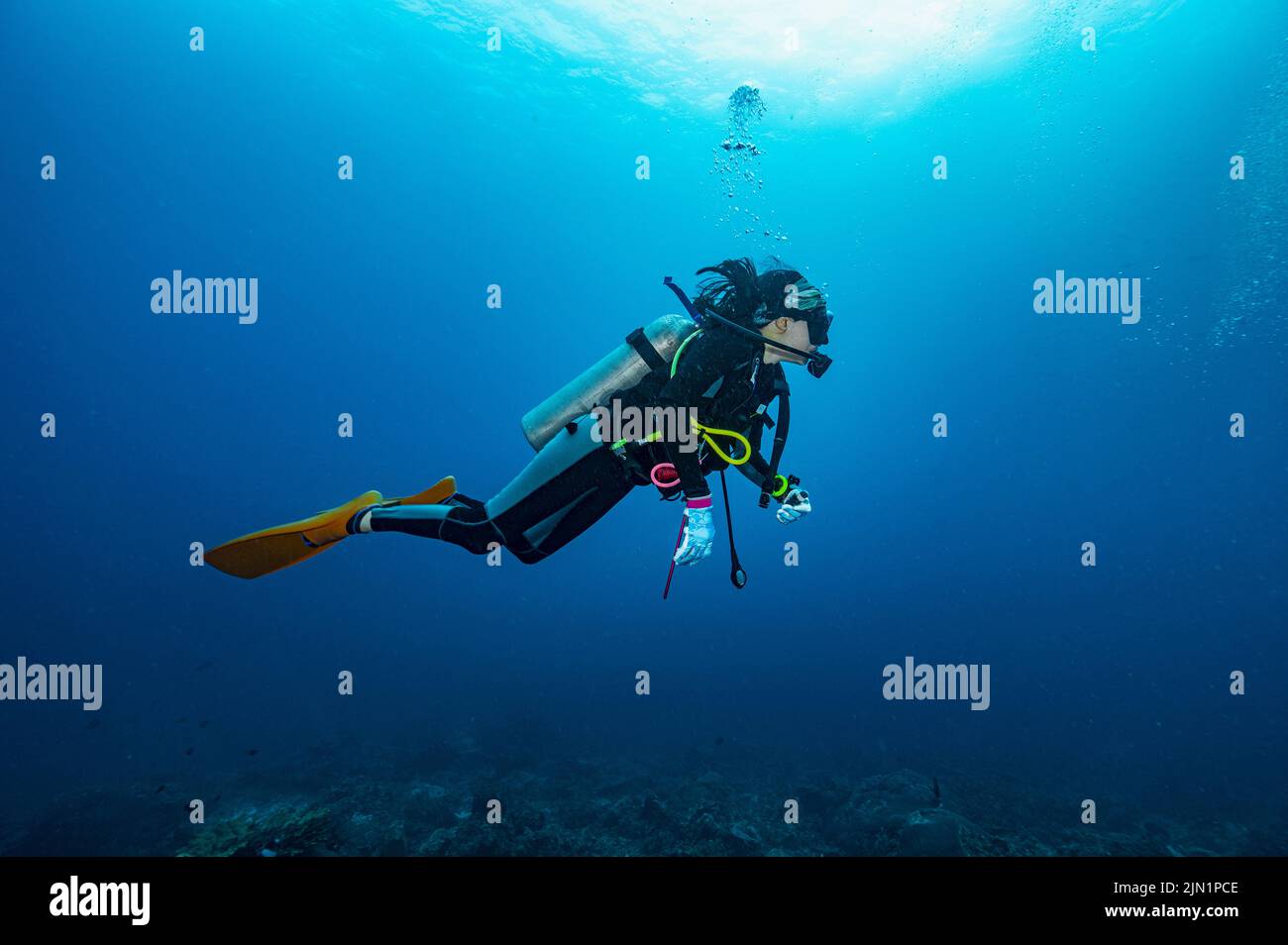 Diver emerging into the tropical waters of the Andaman Sea Stock Photo ...