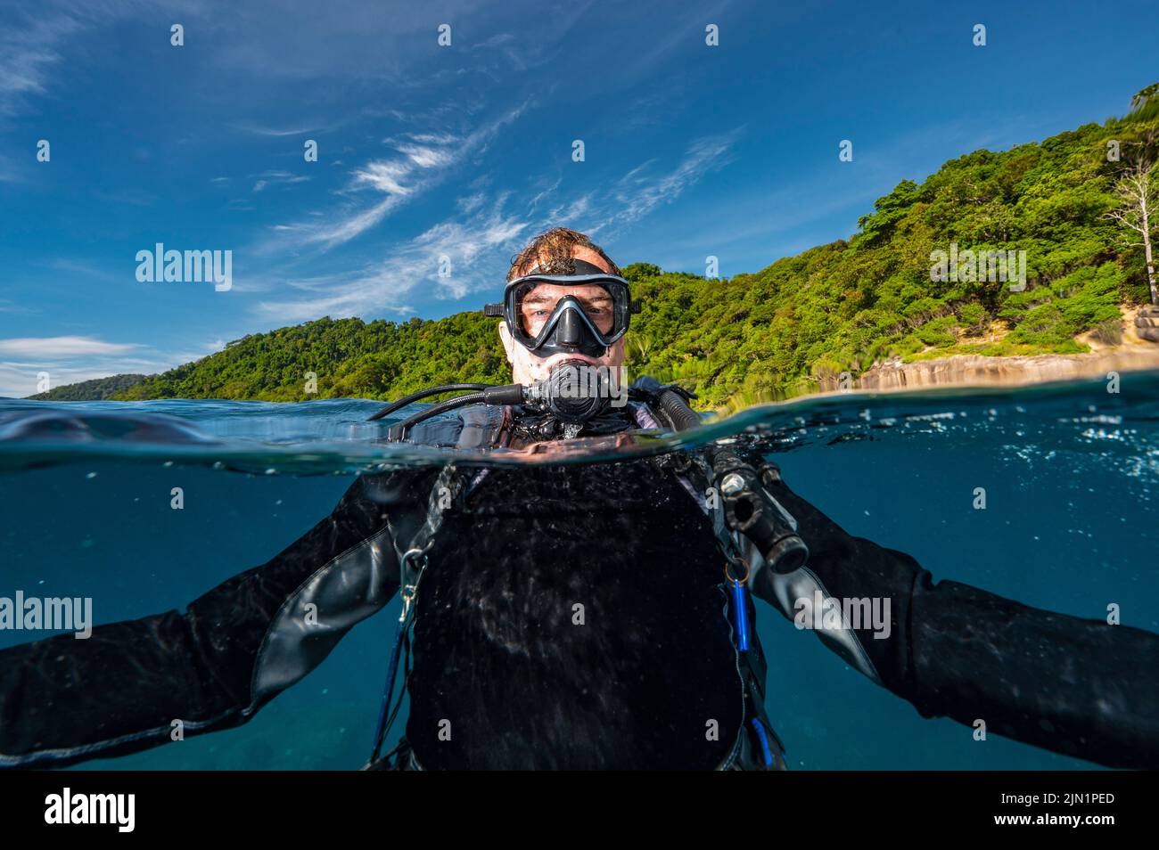 diver surfaces in the tropical waters of the Andaman Sea Stock Photo ...