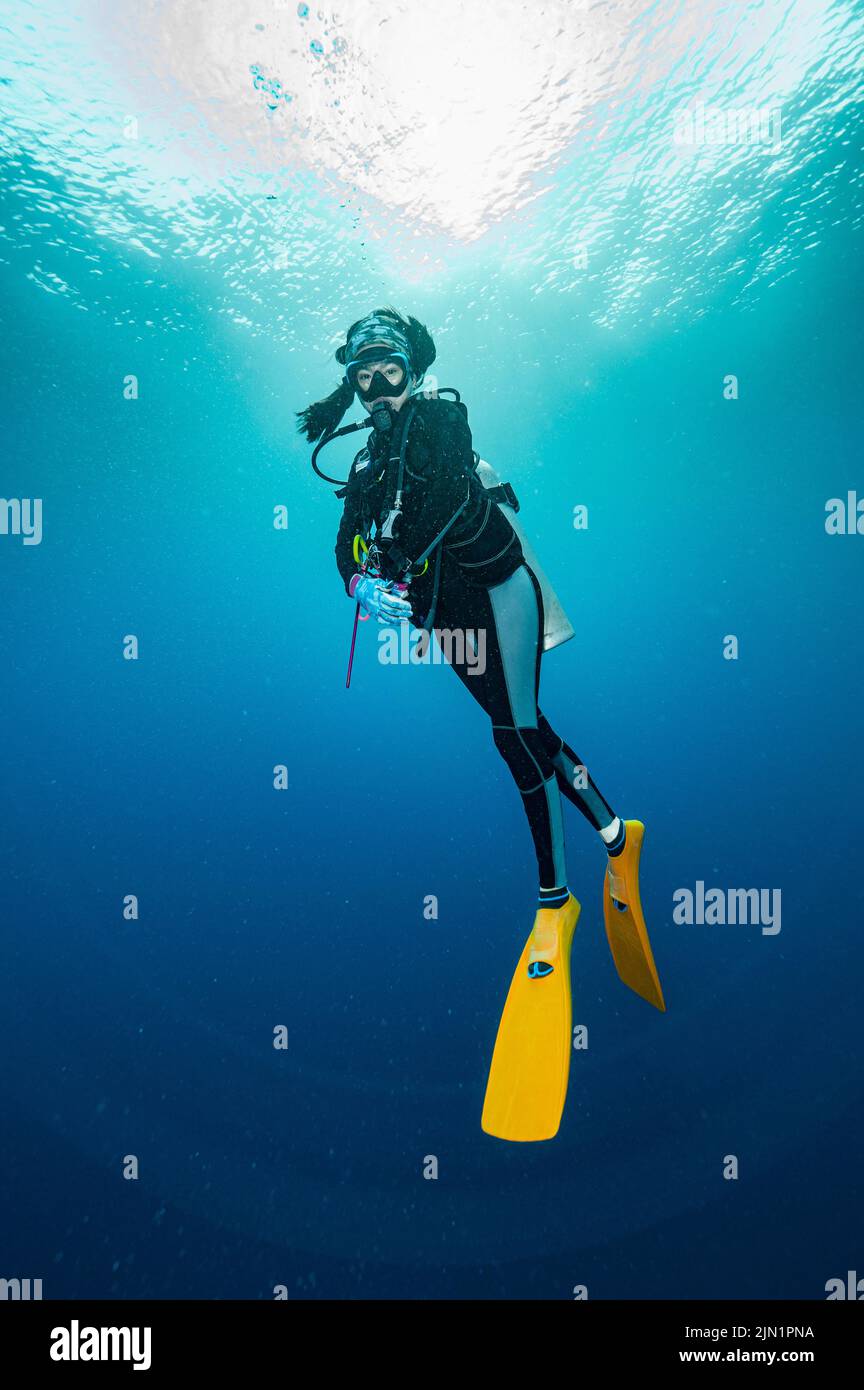 Diver emerging into the tropical waters of the Andaman Sea Stock Photo ...