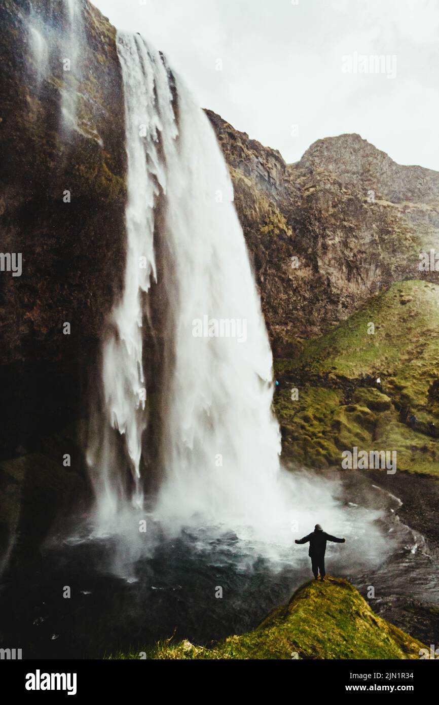 person on a pinion looking at a large waterfall Stock Photo - Alamy