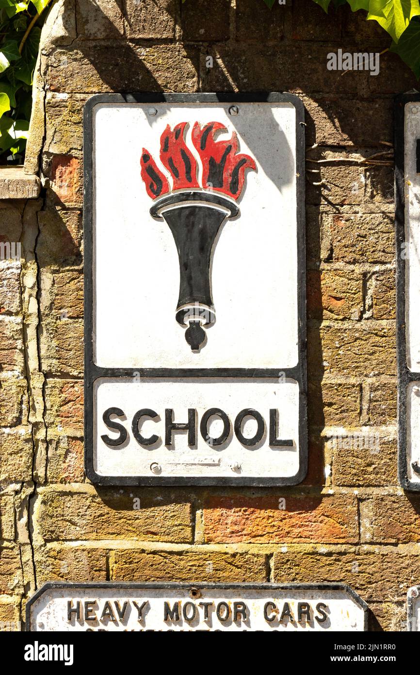 vintage cast metal school road sign with flaming torch symbol at ...