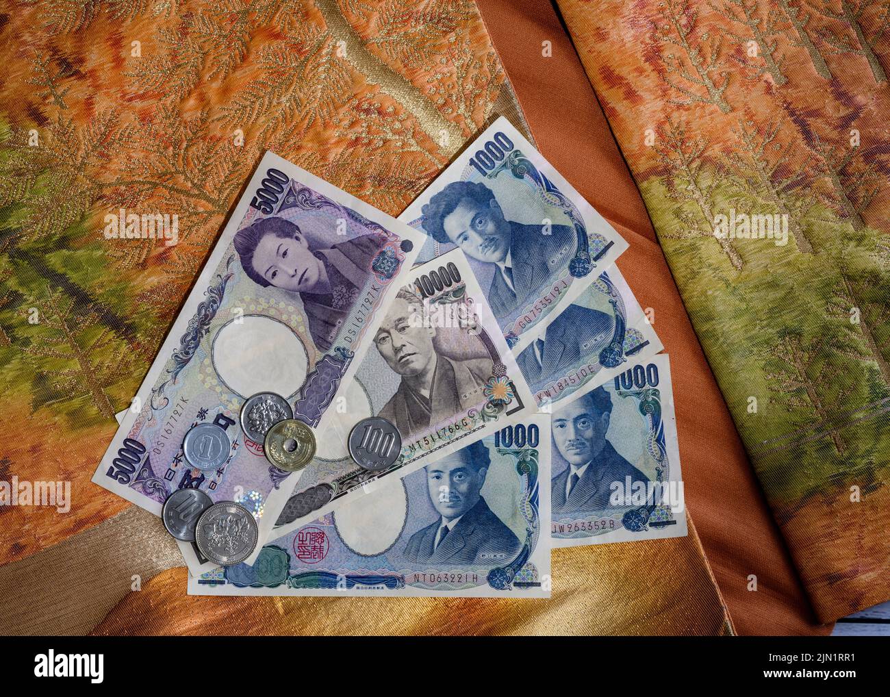 Coins and paper banknotes of Japanese yen on the background of national ...
