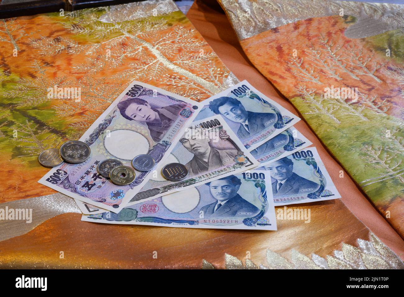 Coins and paper banknotes of Japanese yen on the background of national ...