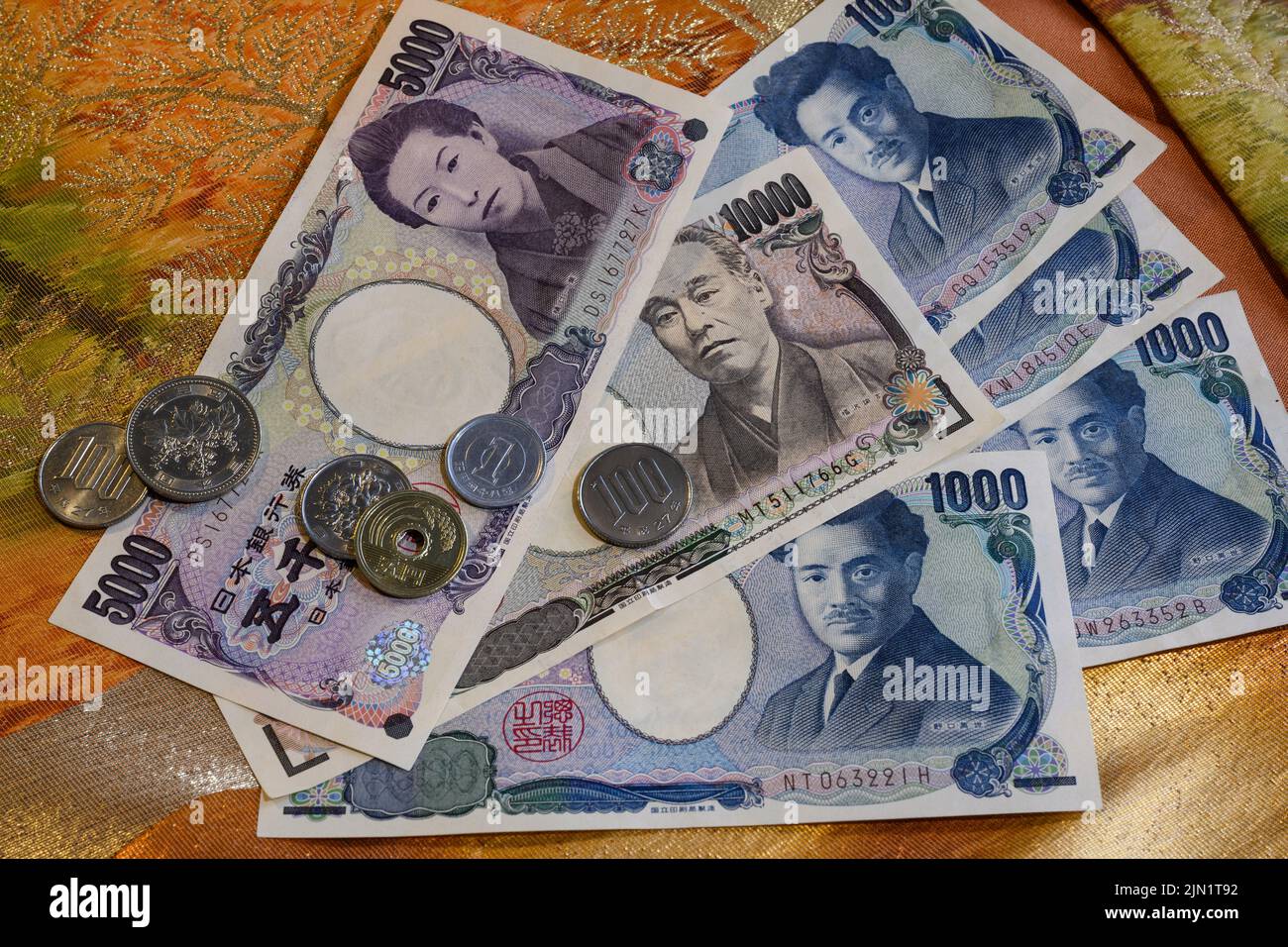 Coins and paper banknotes of Japanese yen on the background of national ...