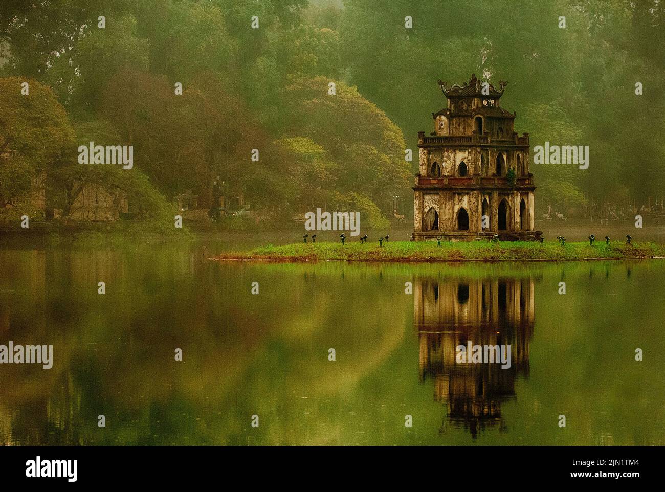 The turtle tower in Hoan Kiem Lake, Hanoi with reflection in the water ...