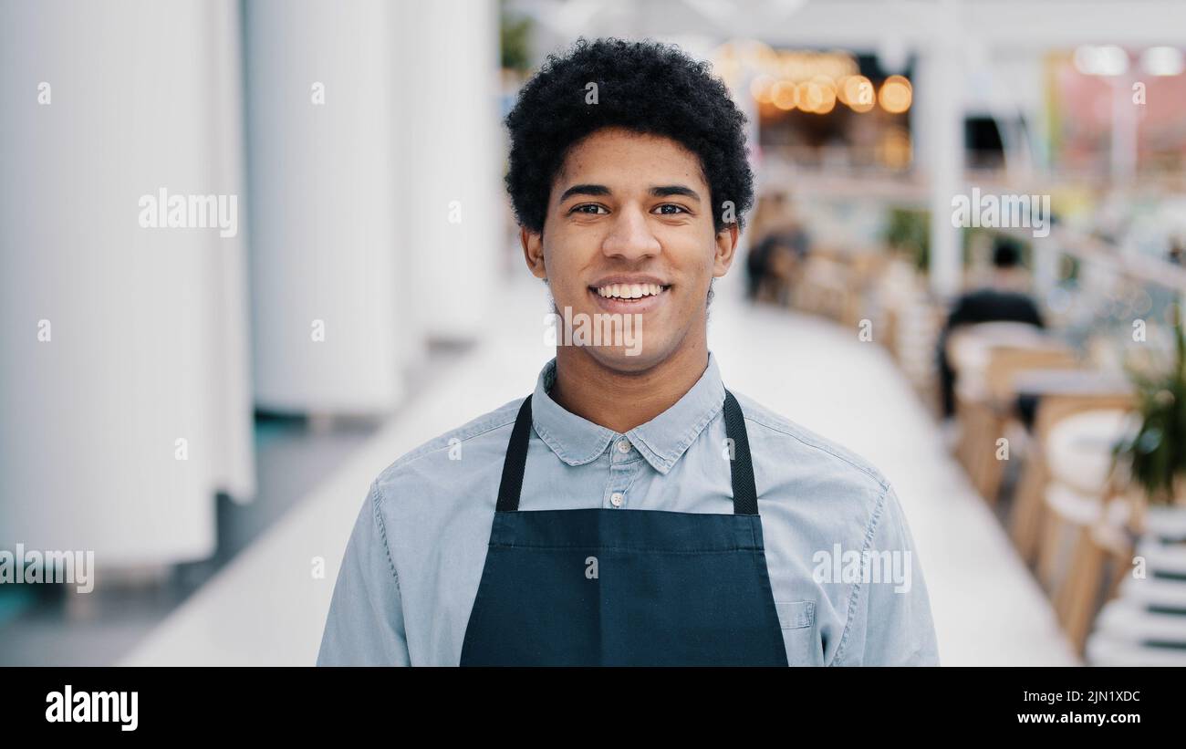Male portrait smiling happy friendly African cafe pub worker biracial ...