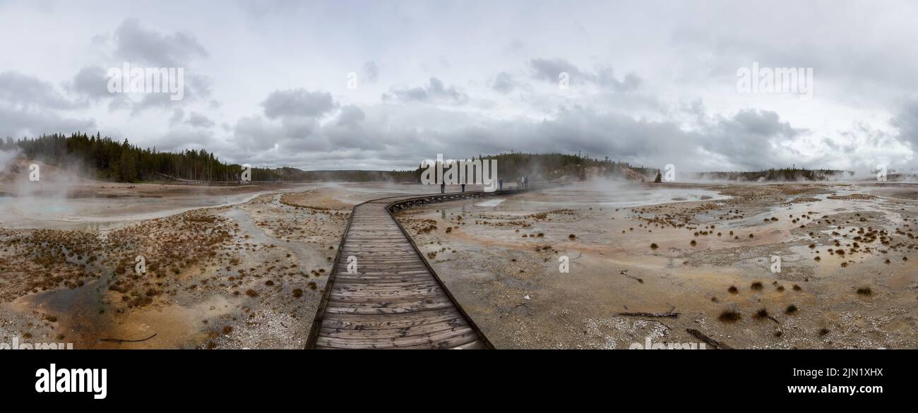 Wooden hiking path in Hot spring Geyser with colorful water in American ...