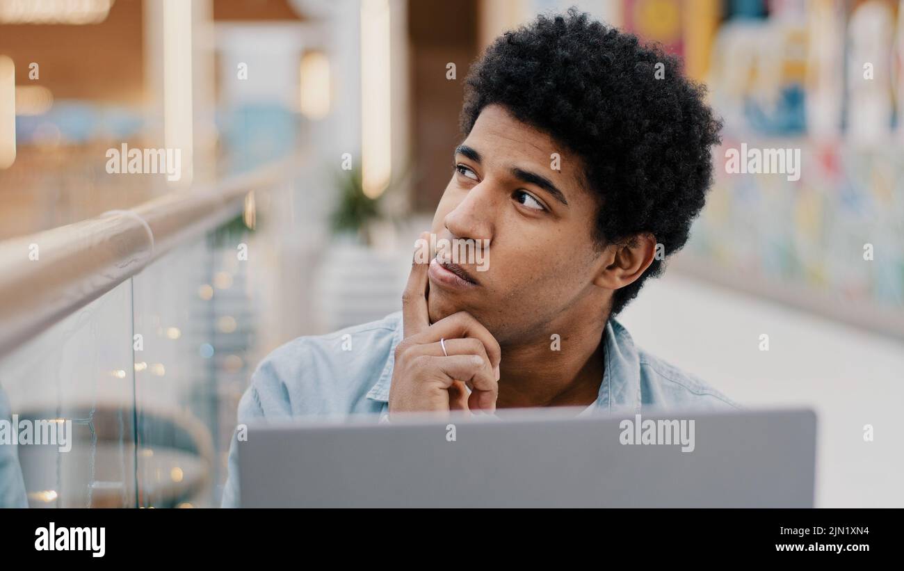 Pensive male african american guy rubbing chin thinking solution ...