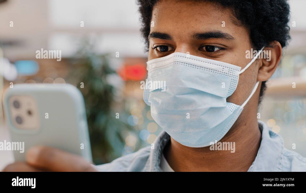 African american masked guy man in medical mask surprised message ...