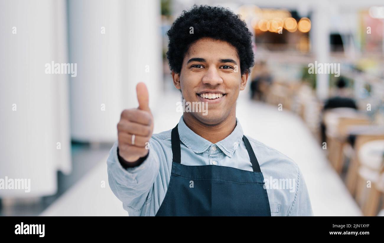 Friendly happy african american male worker waiter salesman in apron ...