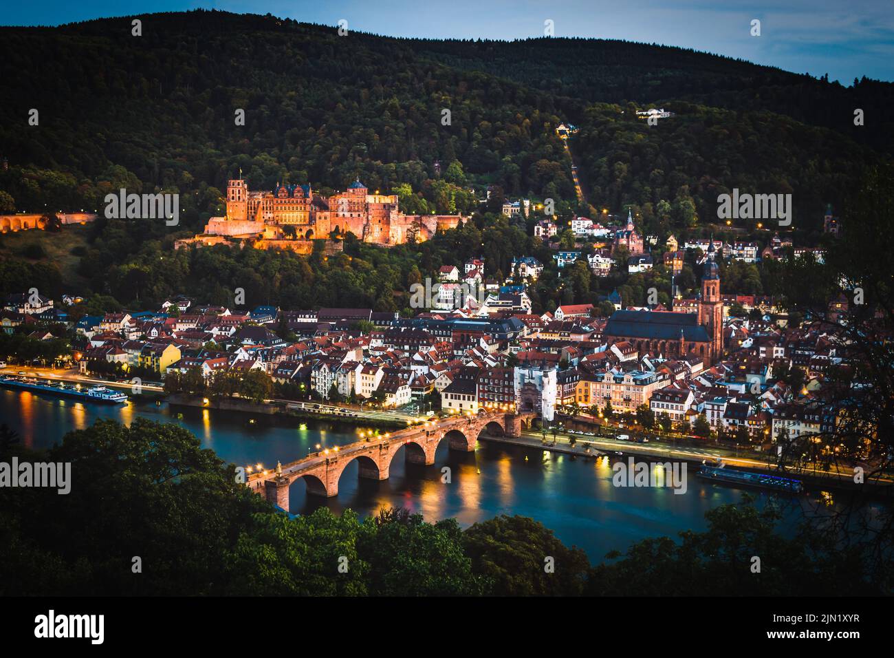 An aerial view of cityscape Heidelberg surrounded by water in evening ...