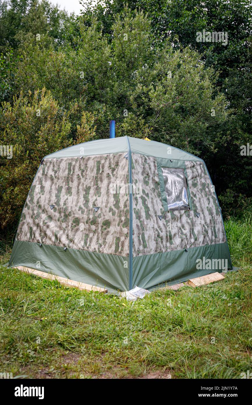 Field bath stands in a field against the background of trees Stock ...