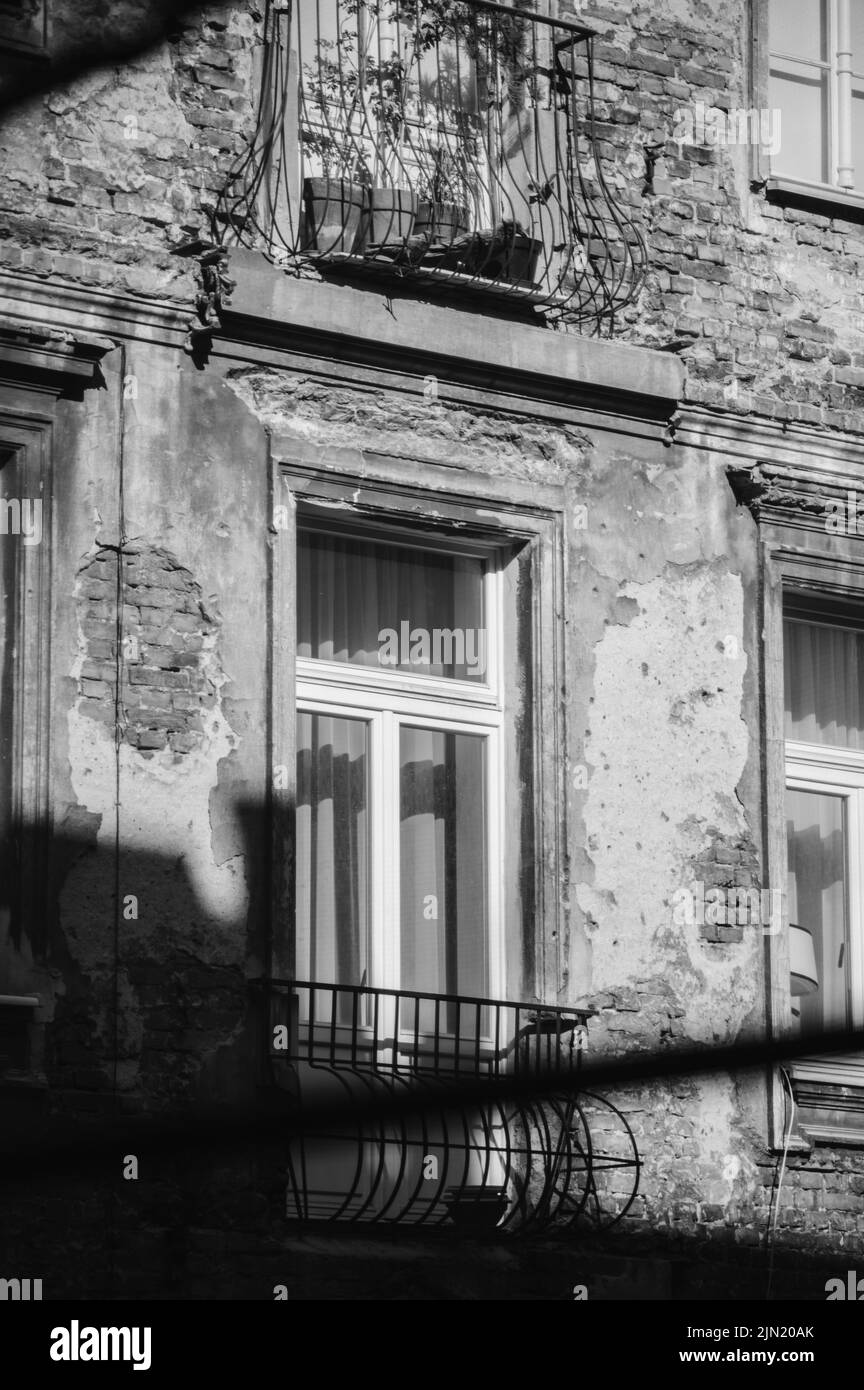 A grayscale of an ancient weathered building with old windows Stock ...