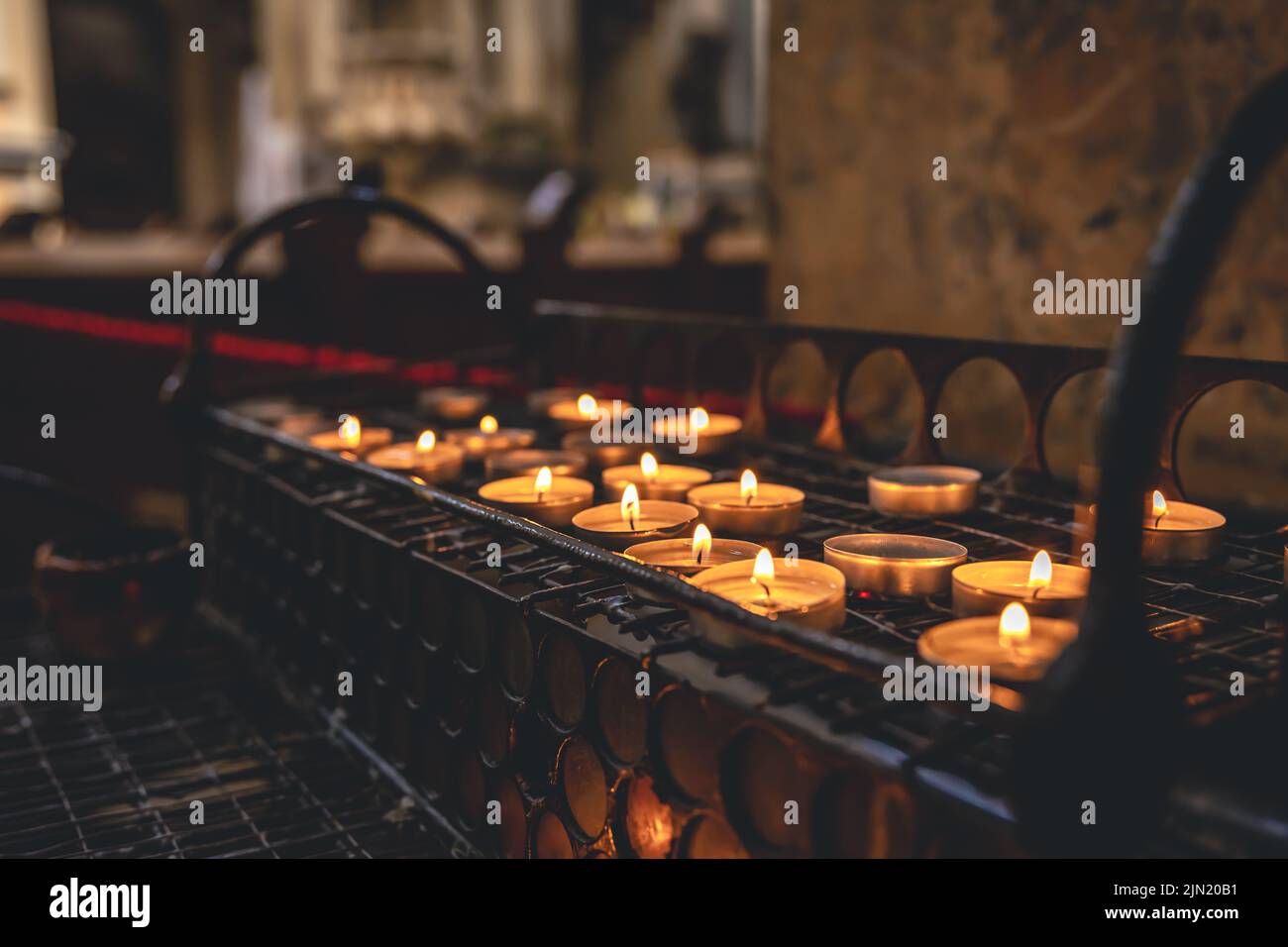 Lots of small candles in a catholic church Stock Photo - Alamy