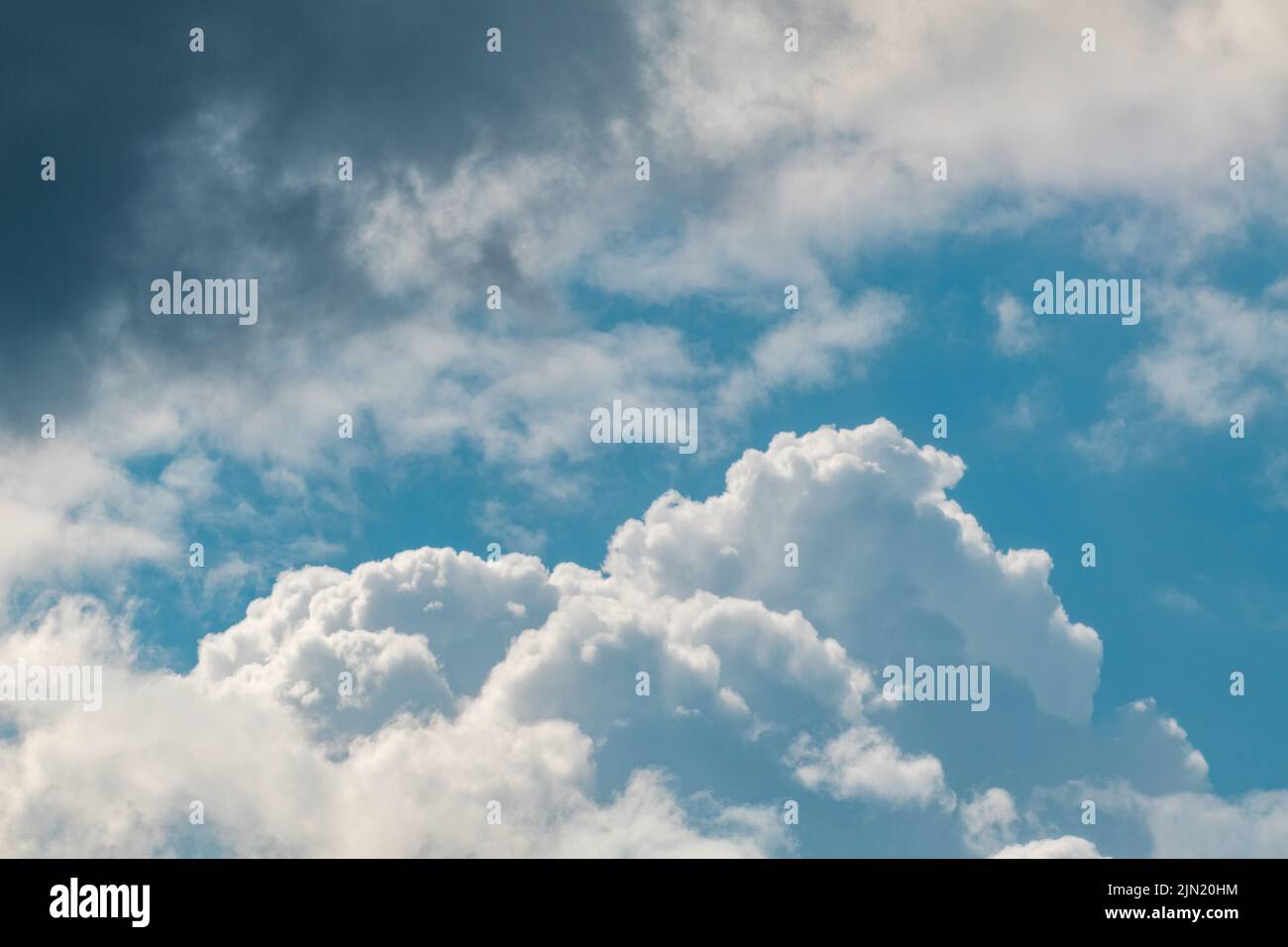 High layered white epic clouds on blue sunny sky. Heavenly cloudscape ...