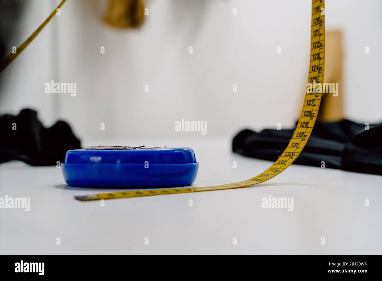 yellow meter for sewing and box of blue needles Stock Photo - Alamy