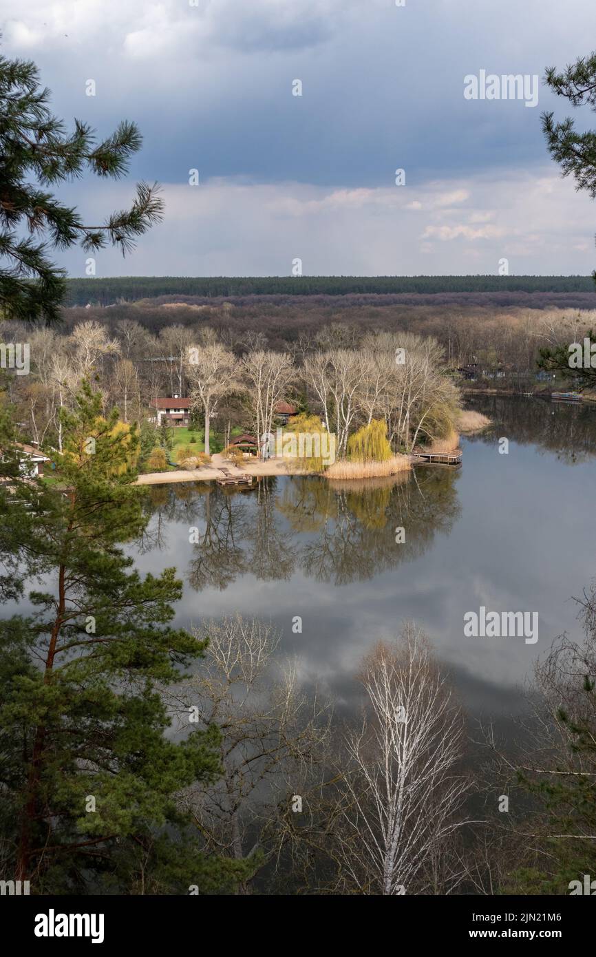 Spring sunny river bank recreation area with rainy clouds. Cossack ...