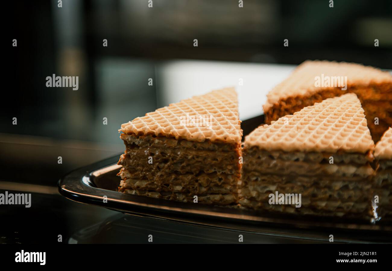 Pieces of waffle cake on display in a cafe Stock Photo - Alamy