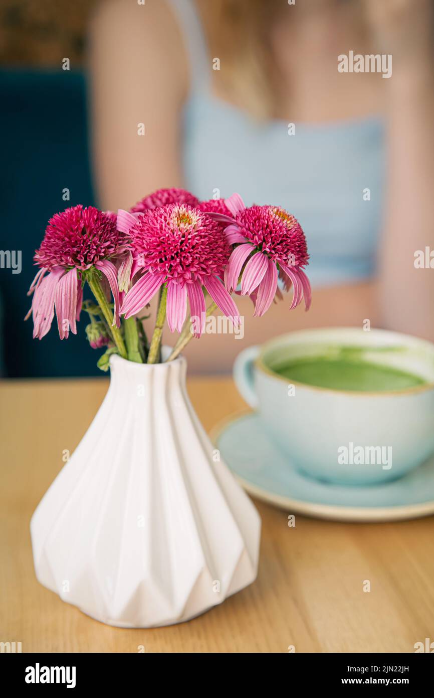 Close-up, a large ceramic cup with a green matcha drink on a wooden ...