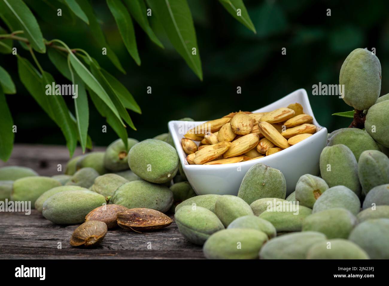 Green almonds background fresh raw unripe wooden rustic table blurred ...