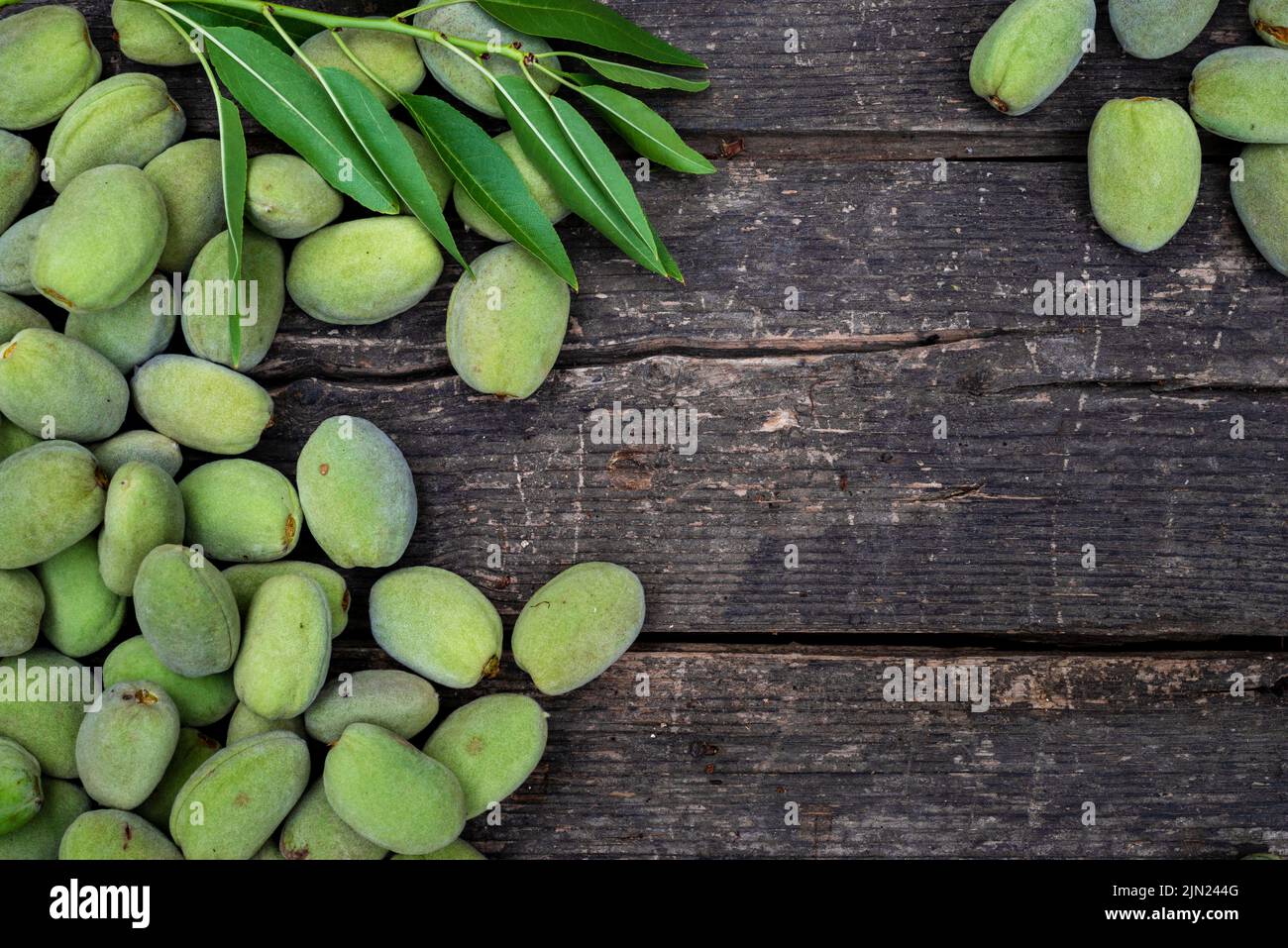 Green almonds background fresh raw unripe wooden rustic table blurred ...