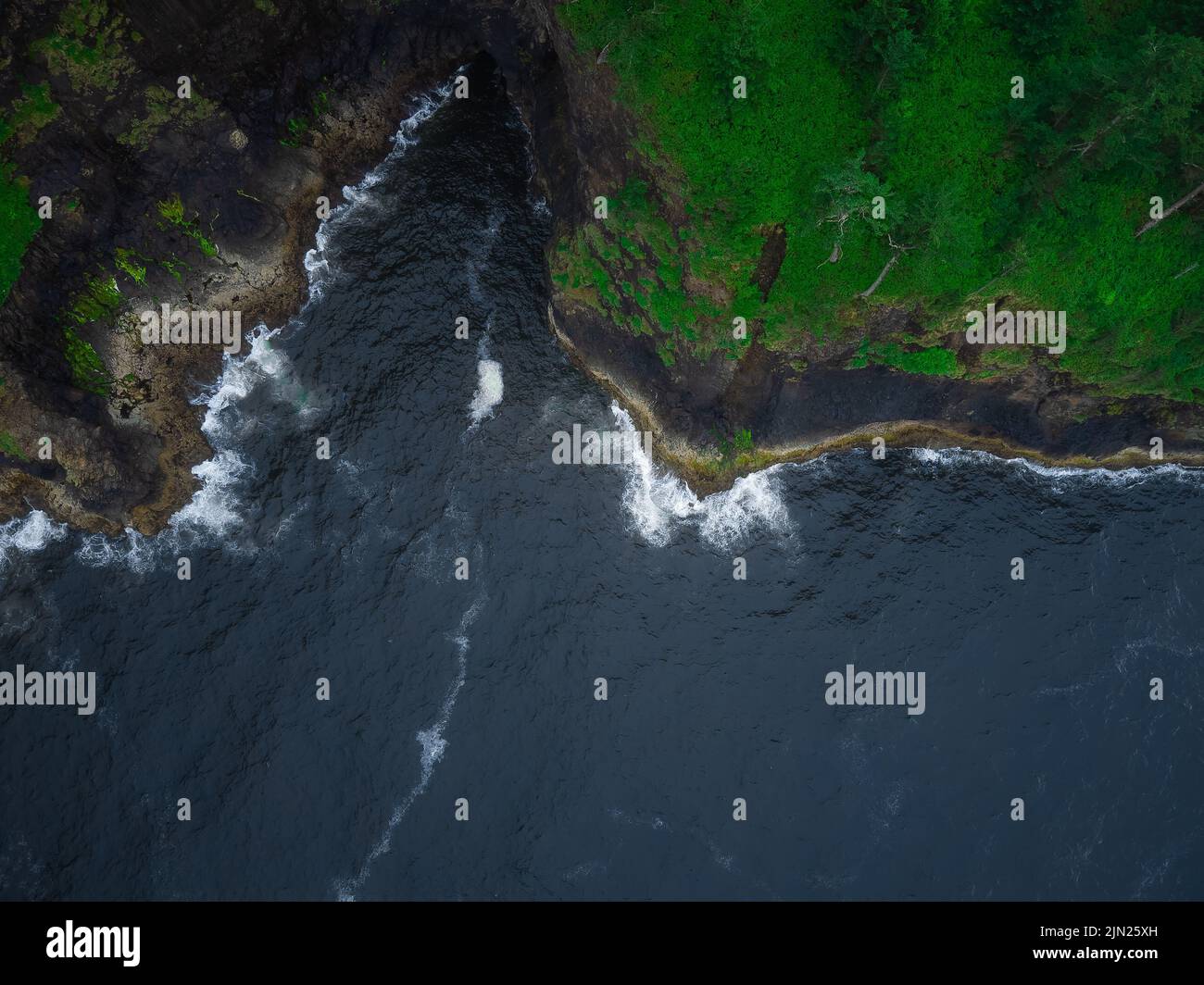 Aerial view. Dark blue ocean and green hilly coast. Calm. Beautiful ...