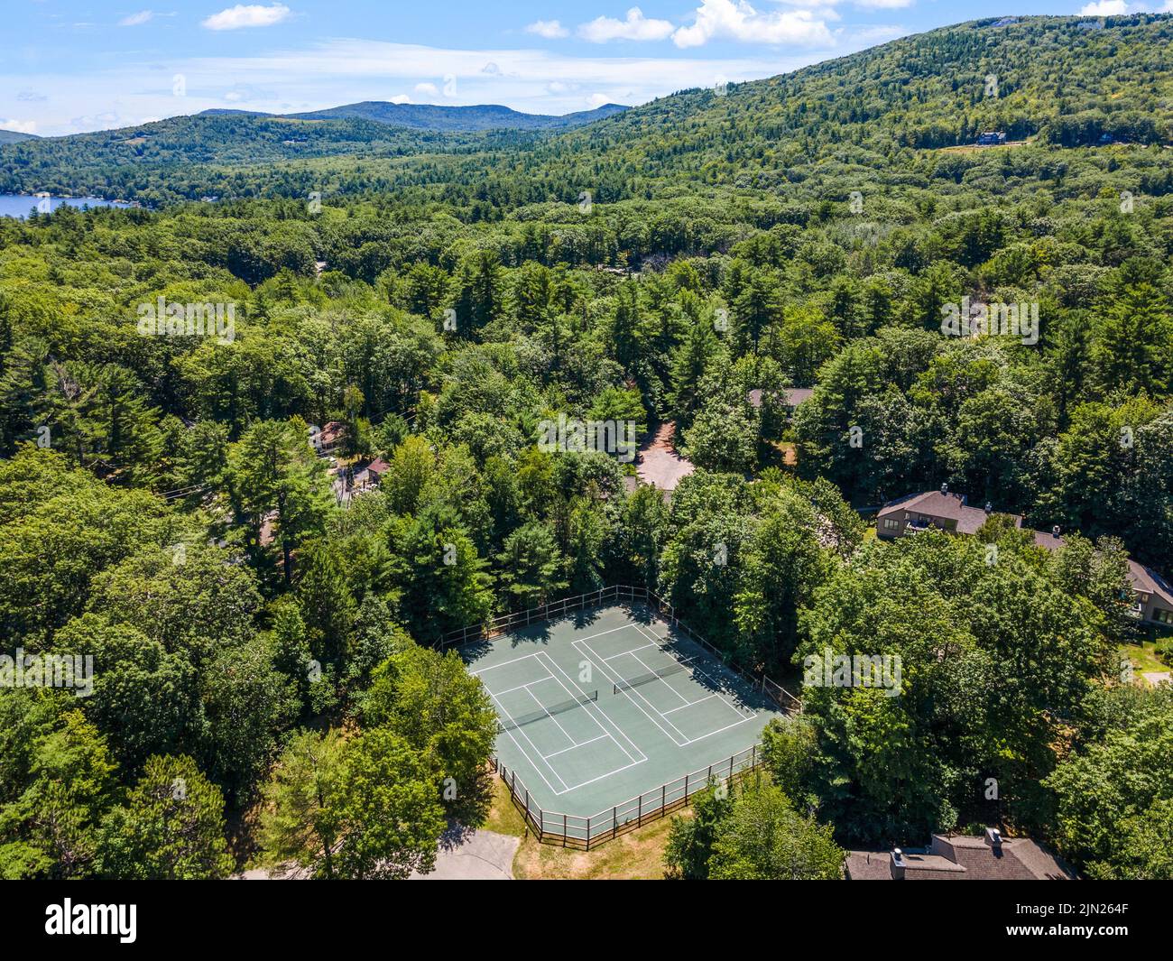An aerial view of outdoor tennis courts surrounded by green trees Stock ...
