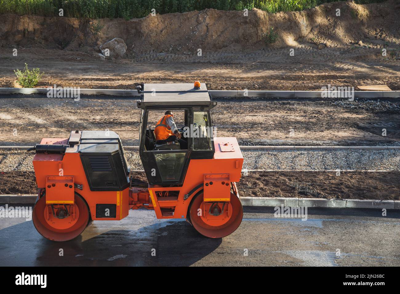Road roller rolls out asphalt. Road construction concept Stock Photo ...