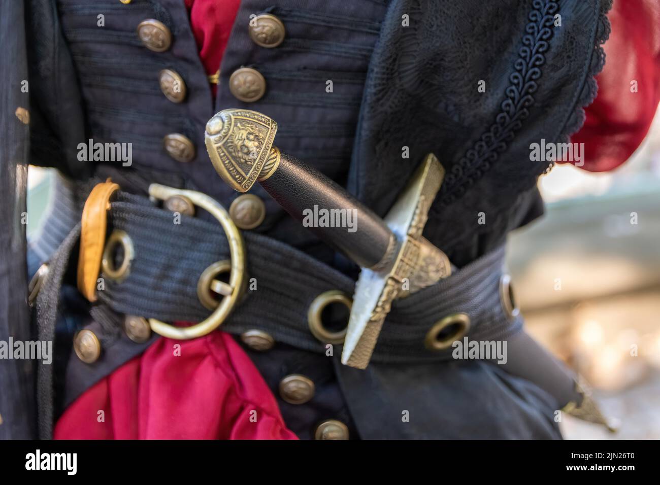 The close-up partial view of a pirate costume with a dagger in the belt ...