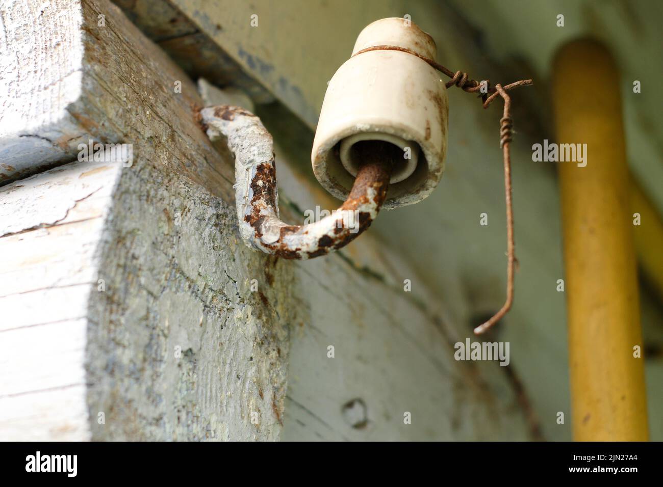 White ceramic insulator with rusty wire Stock Photo - Alamy