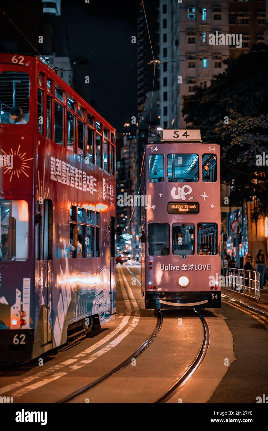 A vertical shot of a tram still running late at night in Wanchai, Hong ...