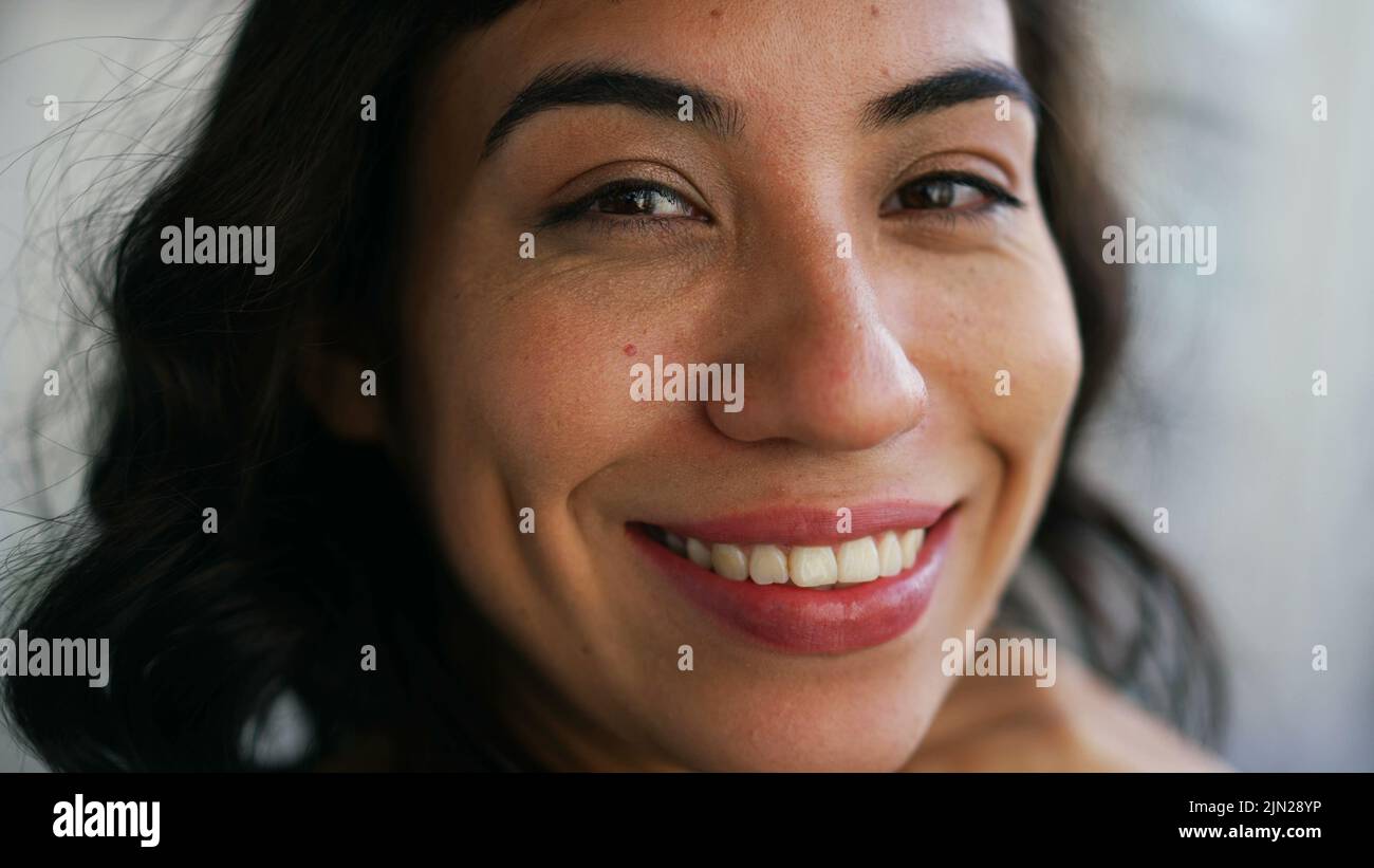 One hispanic latin young woman closeup face smiling at camera. Portrait of a happy South ...