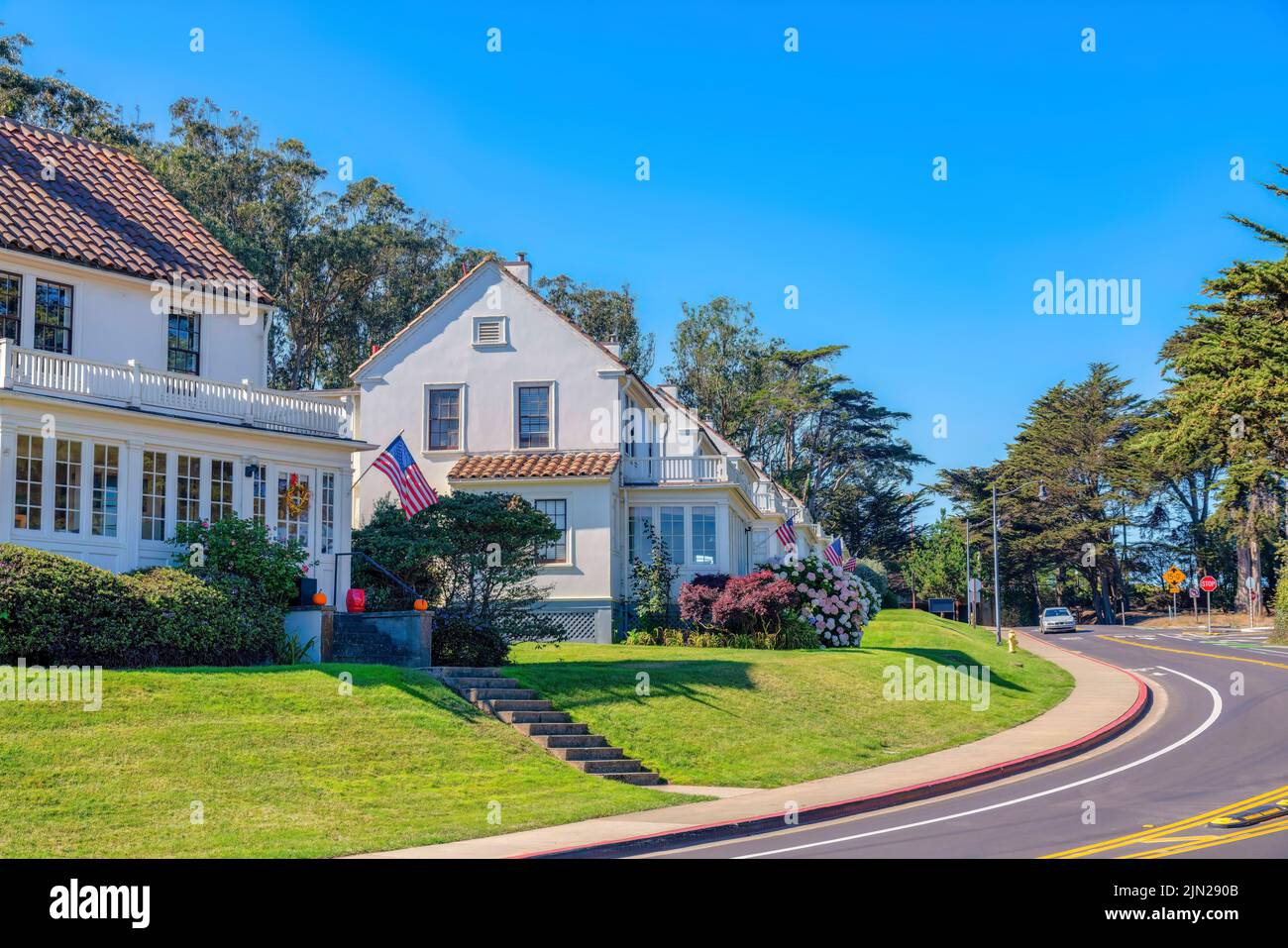 Suburban neighborhood with sloped lawn near the curved street in San ...