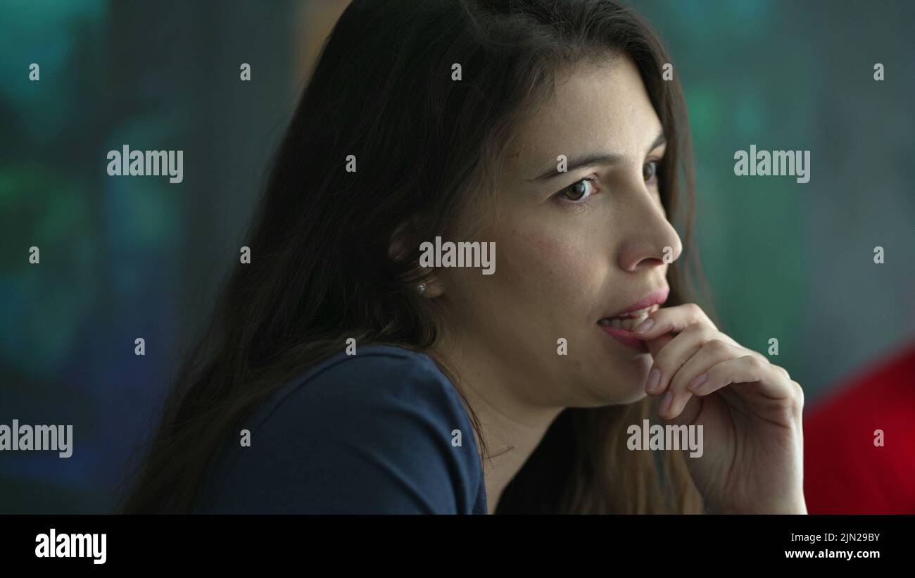 Fearful young woman face biting nail feeling anxiety. Pensive restless ...