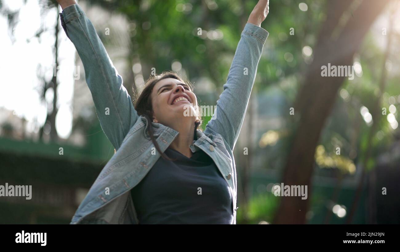 Happy woman celebrating achievement raising arms in the air feeling ...