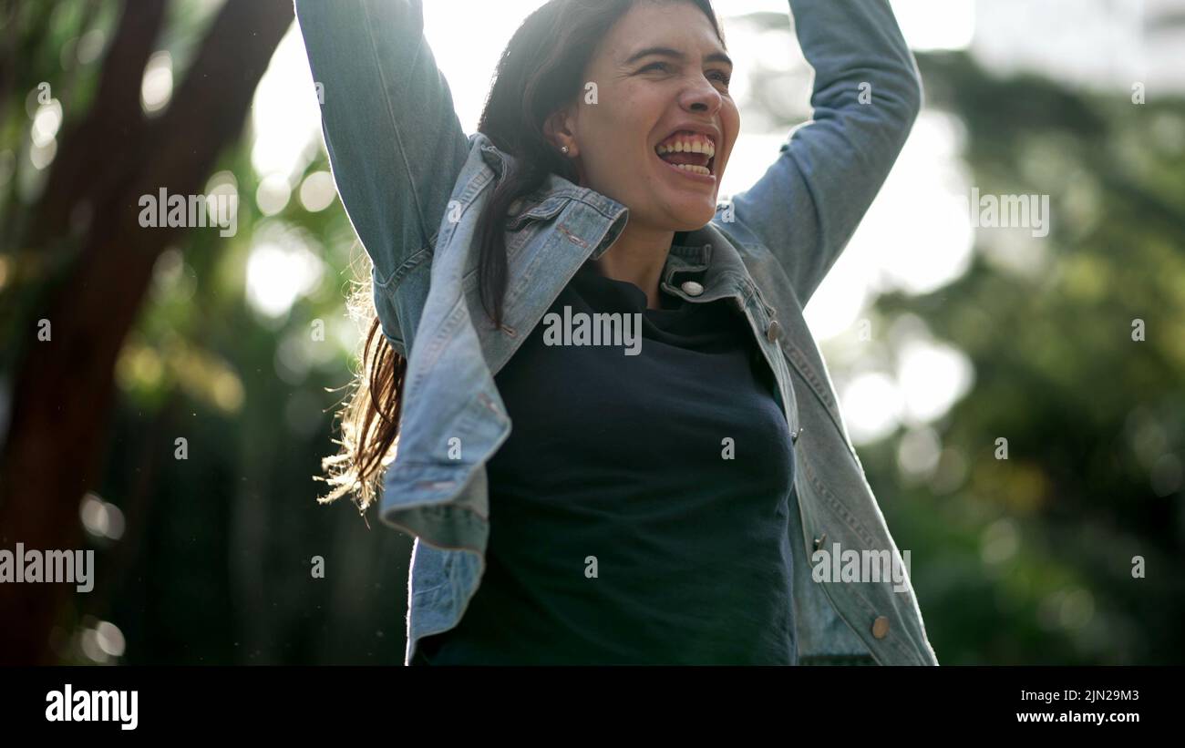 Happy woman celebrating achievement raising arms in the air feeling ...
