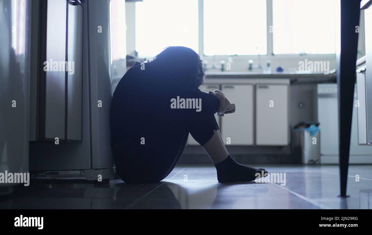 Dramatic moment of young woman suffering from mental illness sitting on ...