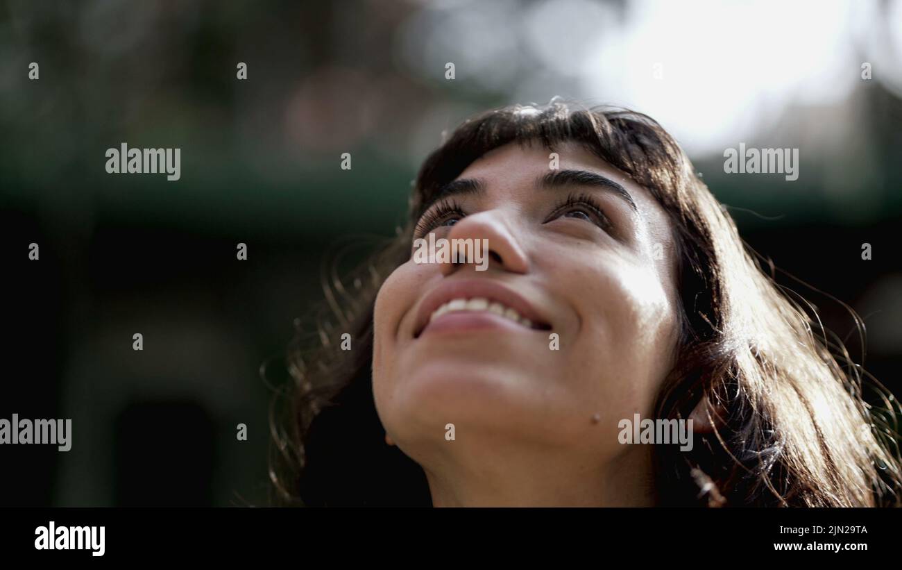 Contemplative young woman looking up at sky with HOPE and FAITH ...