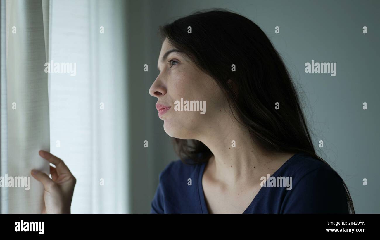 Woman looking through blinds scared hi-res stock photography and images ...