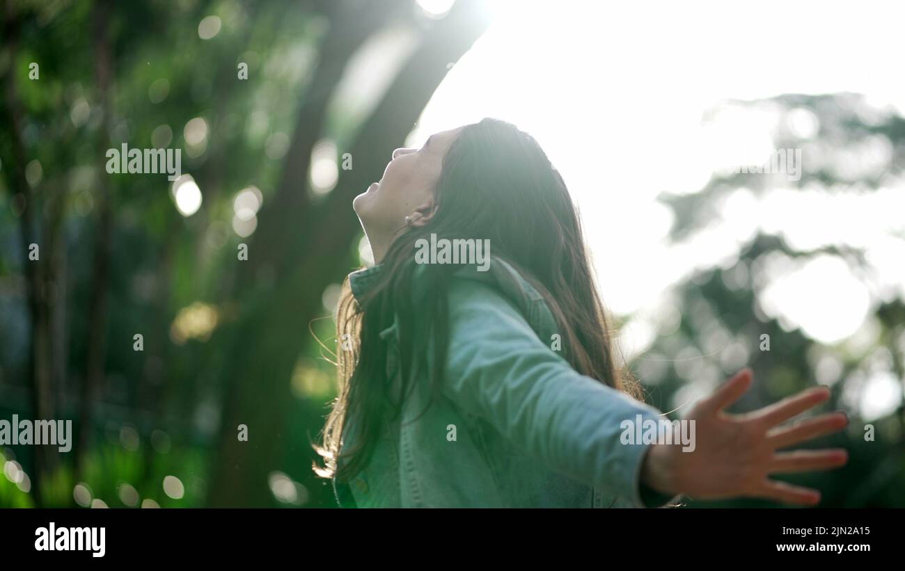 Excited woman raising arms celebrating life in nature. Happy person ...