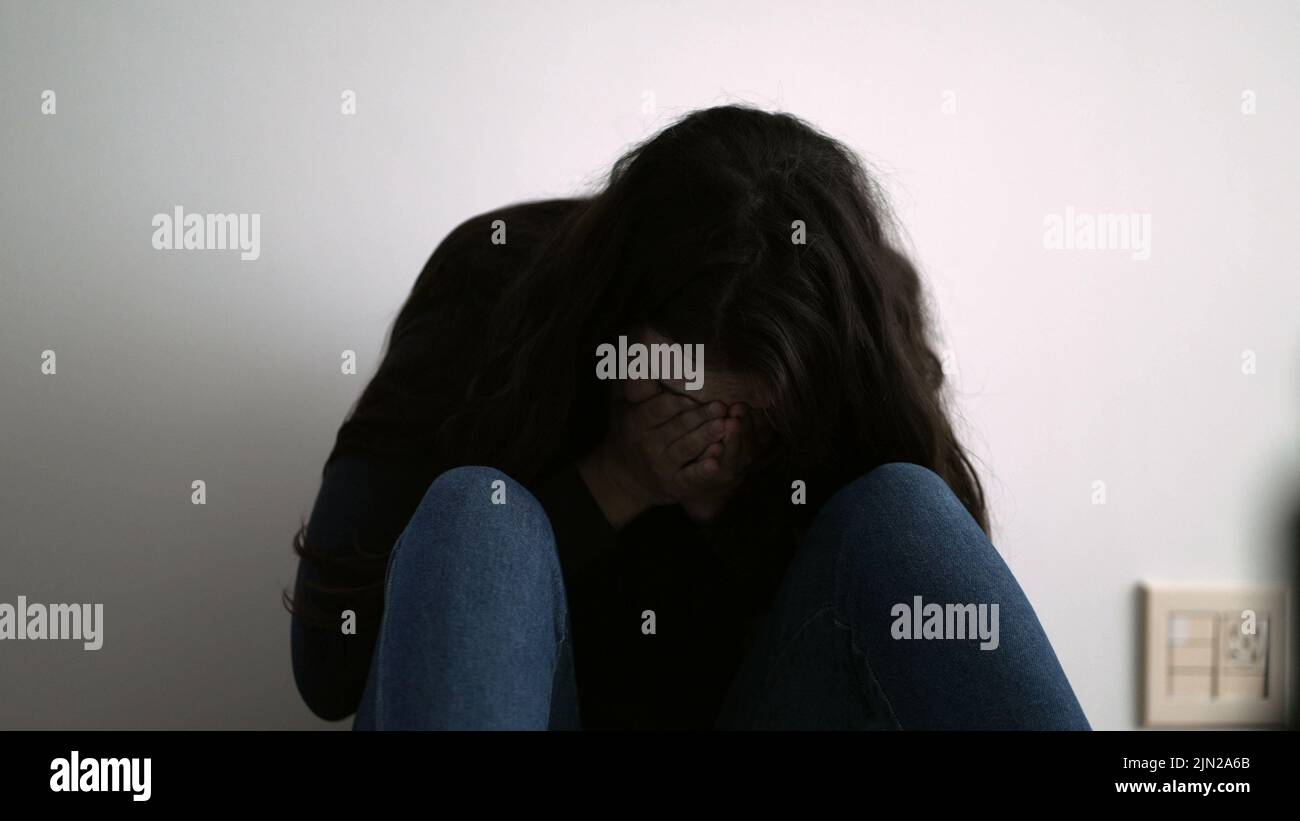 Woman covering face with shame suffering of mental illness. Person ...