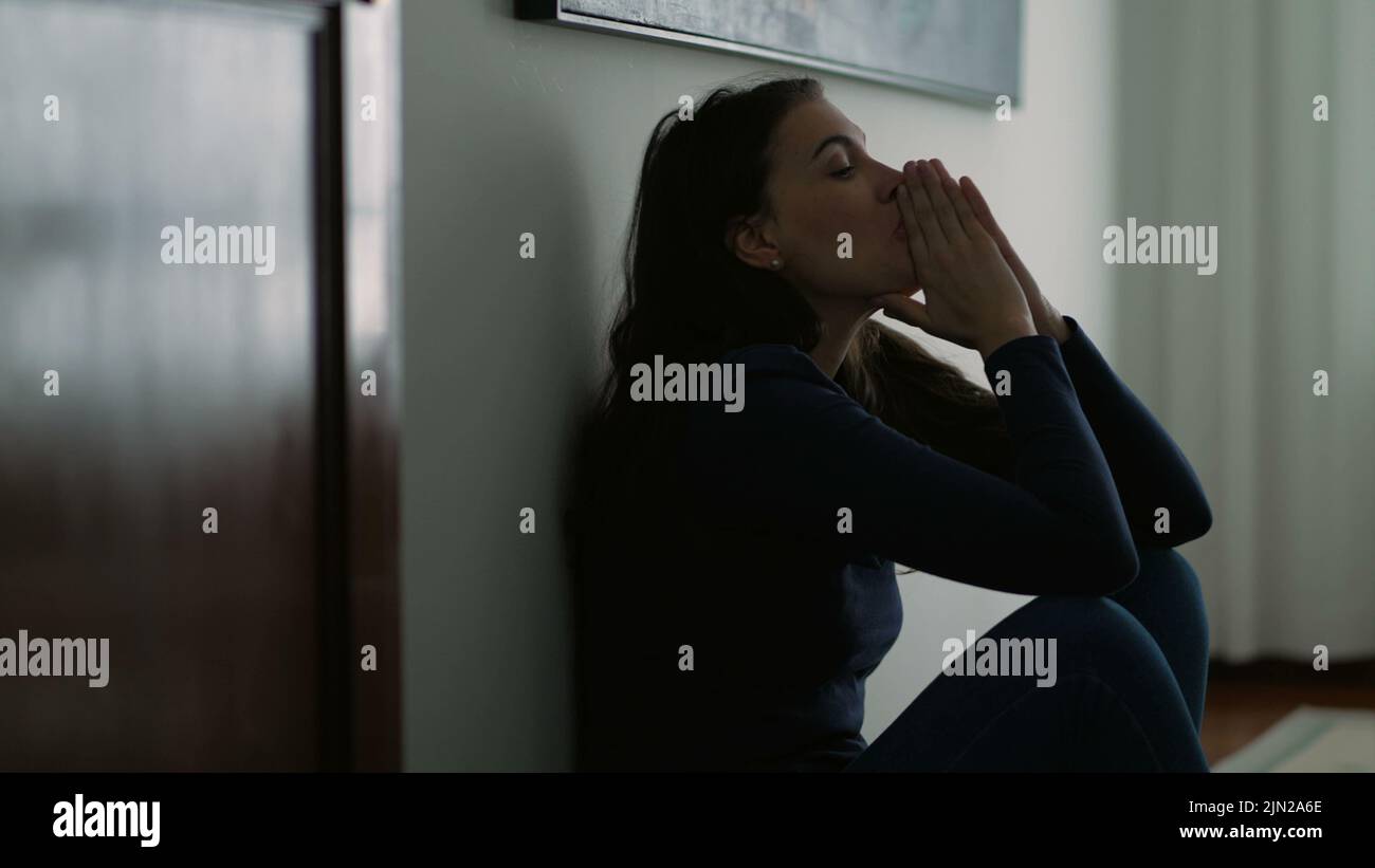 Woman feeling emotional pain sitting on floor home being desperate ...