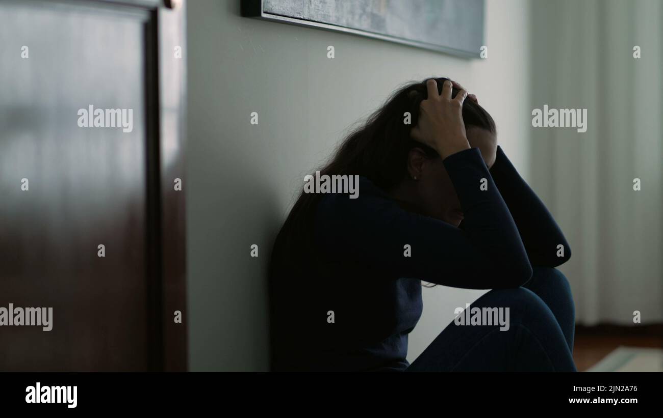 Woman feeling emotional pain sitting on floor home being desperate ...