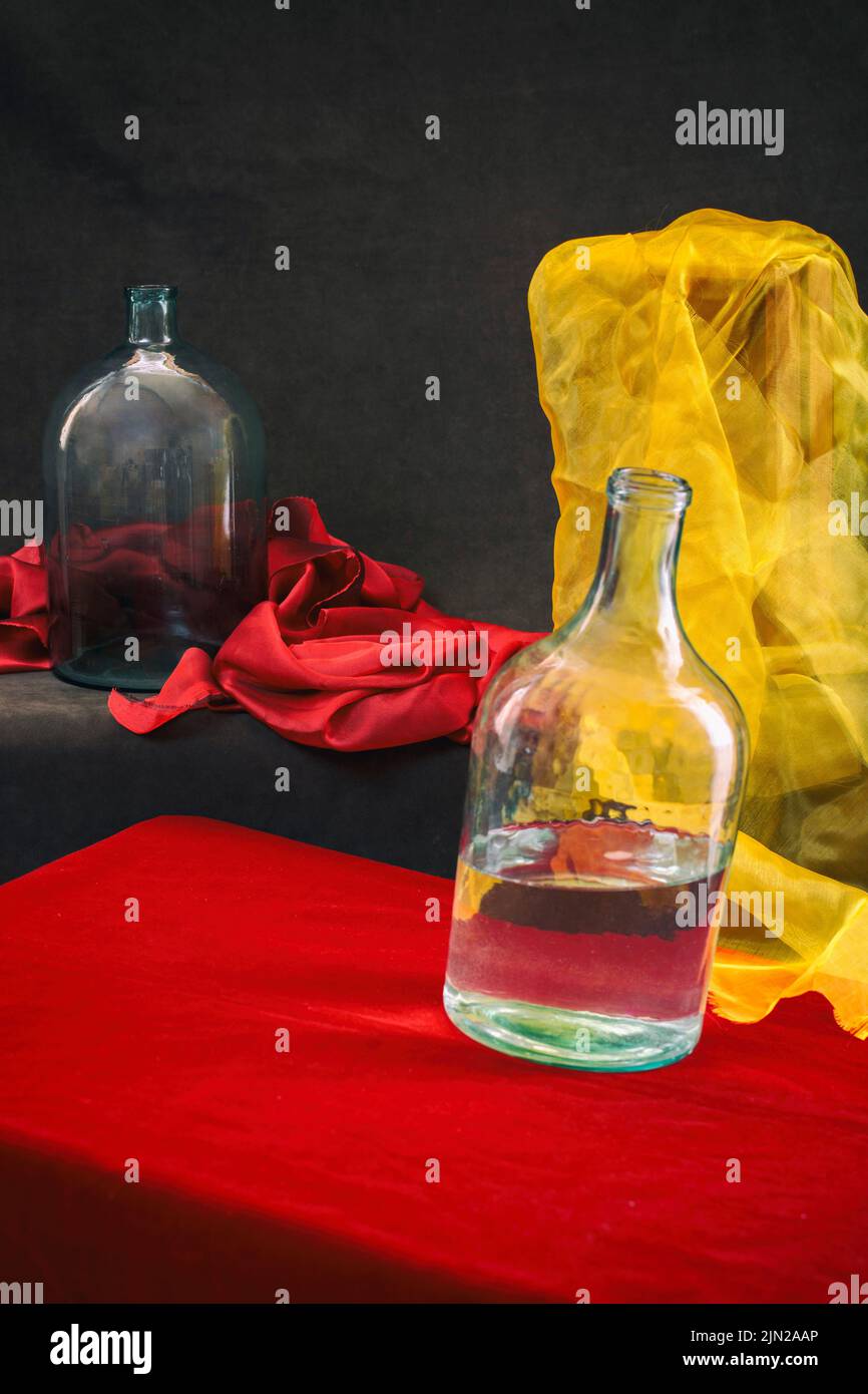 Still life with glass jars and yellow and red fabric Stock Photo - Alamy